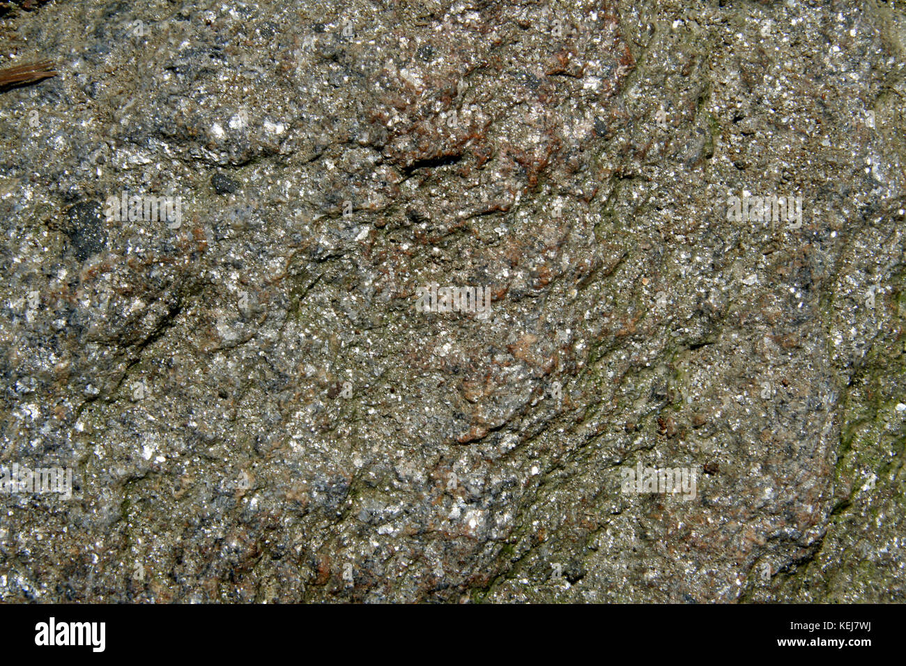 Rough rock surface with multicoloured, shiny grains Stock Photo - Alamy