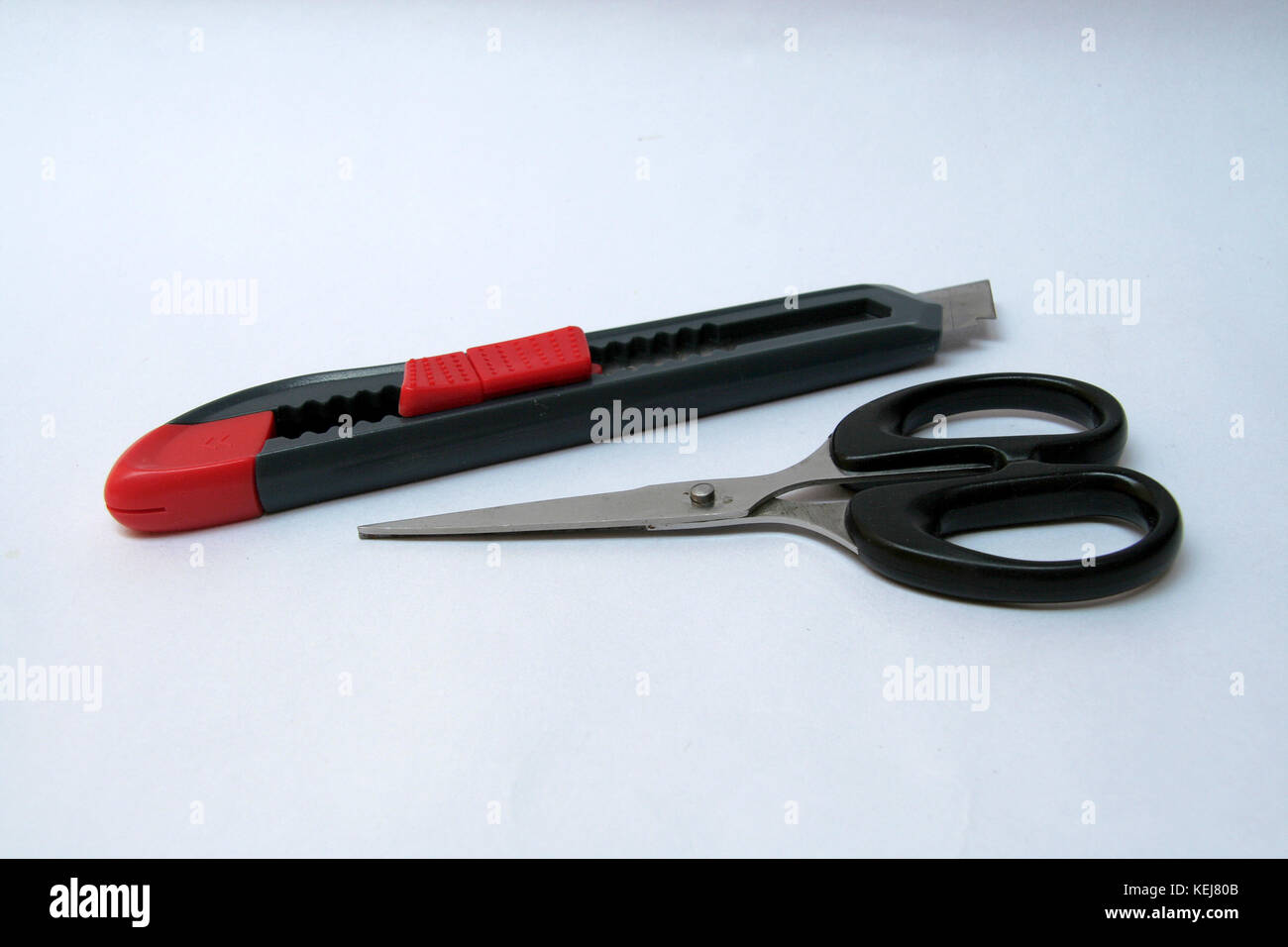 Pair of scissors and cutter used for paper artwork Stock Photo - Alamy