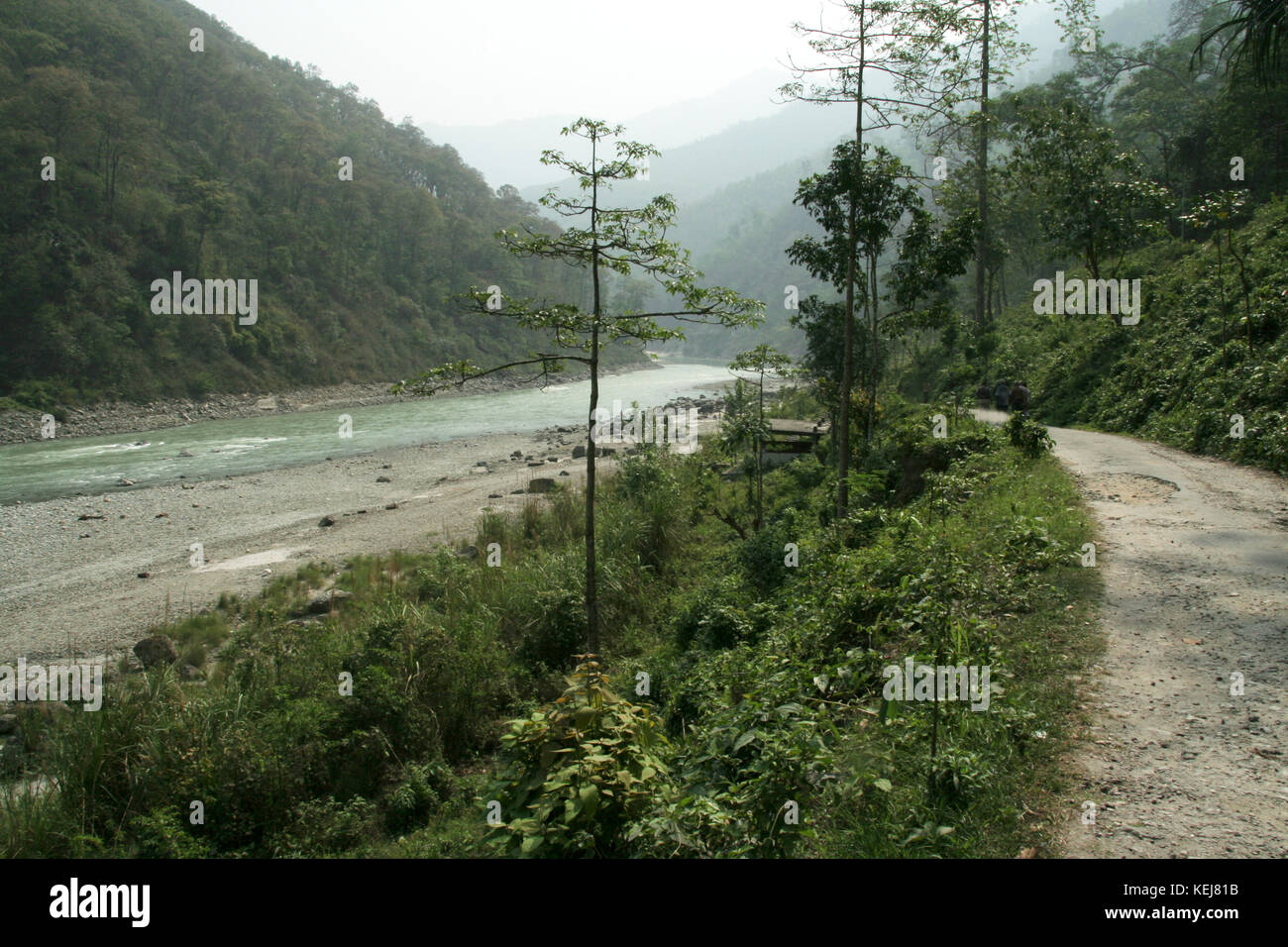 Road running parallel to river in mountain valley Stock Photo - Alamy