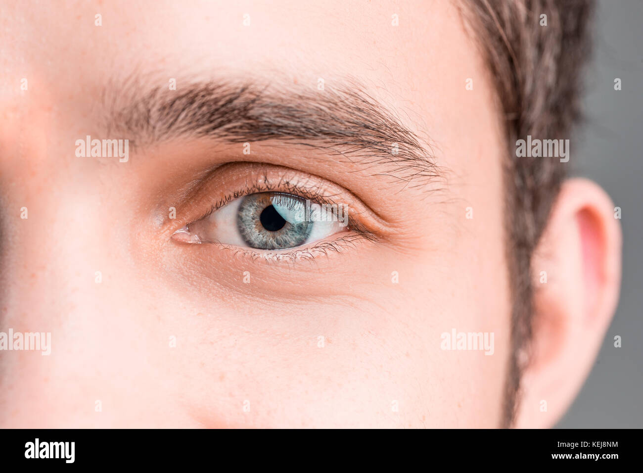 The conceptual image of digital eye of a young man and eoman Stock ...