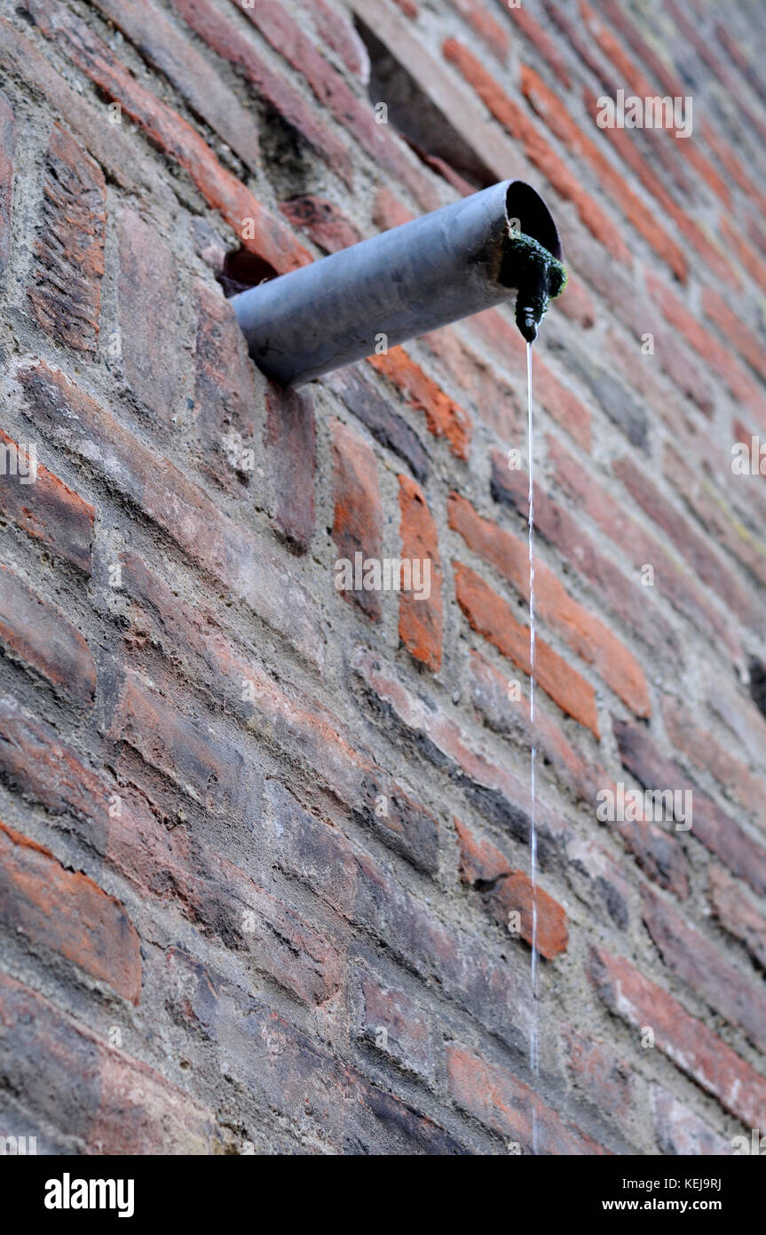 brick wall with drippy tube Stock Photo - Alamy