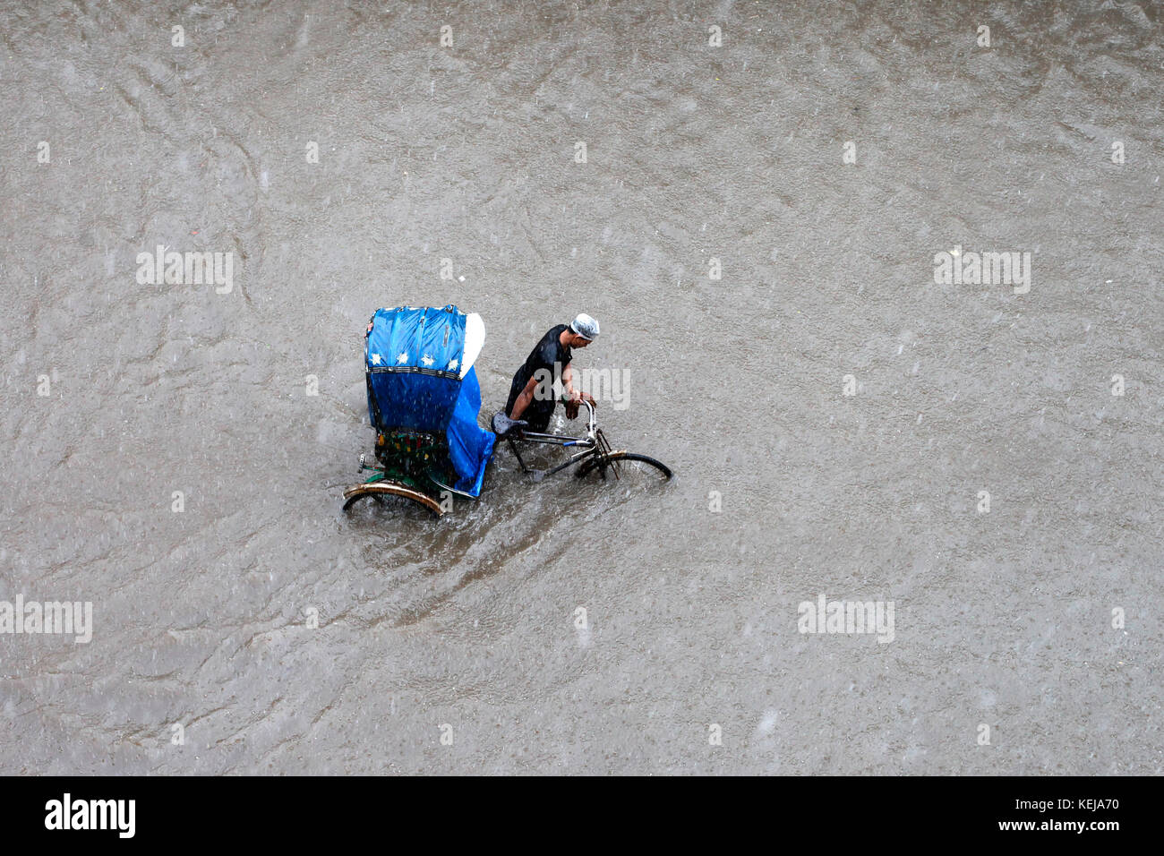 The waterlogged road during a downpour in Dhaka on October 21, 2017 ...