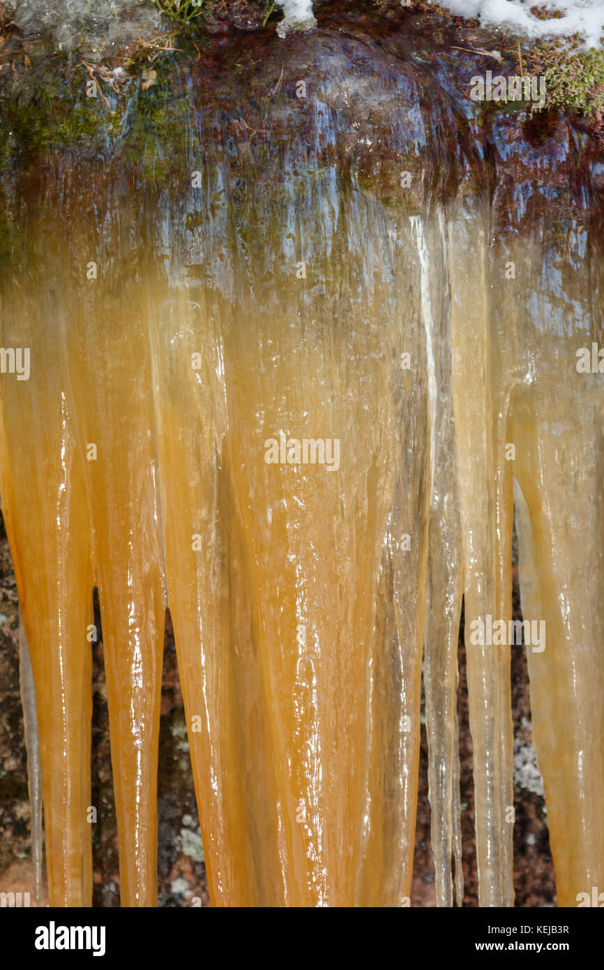 brown colored icicles hanging from a cliff Stock Photo - Alamy