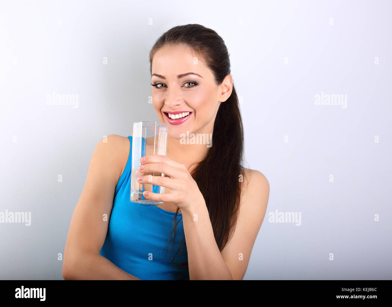 Toothy Smiling Beautiful Woman Drinking Fresh Pure Water From Glass On