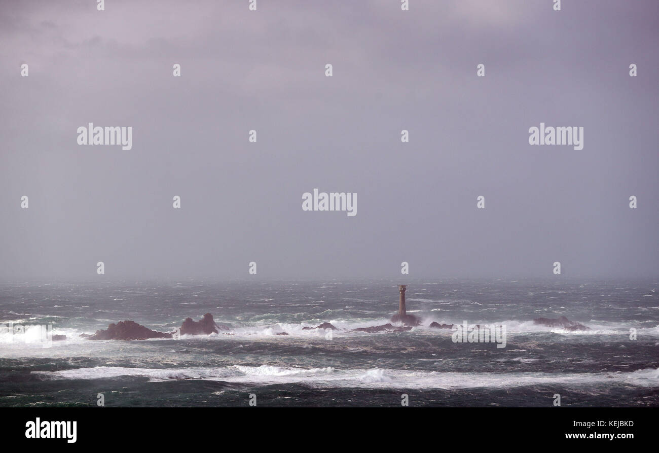 Waves crash around the Longships lighthouse off of Land's End in ...
