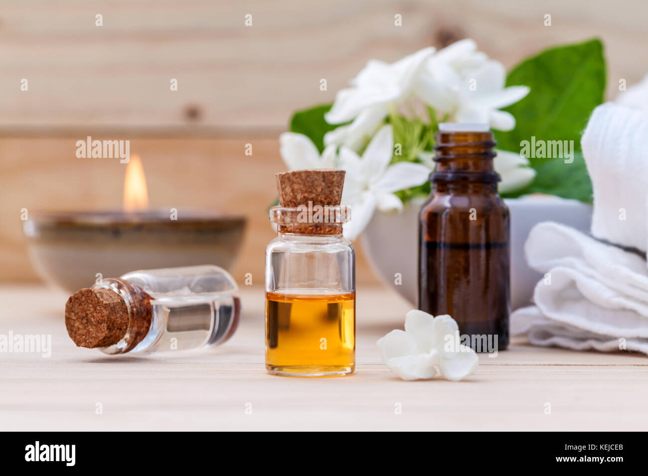 Bottle of essential oil and jasmin flower with shallow depth of field ...