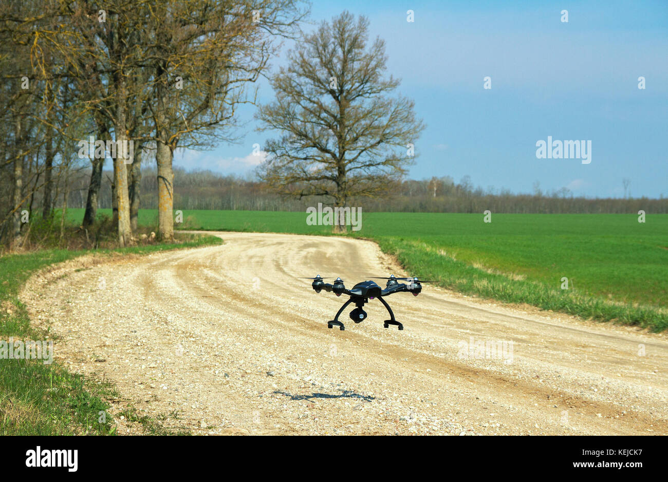 Drone flying above gravel road Stock Photo - Alamy