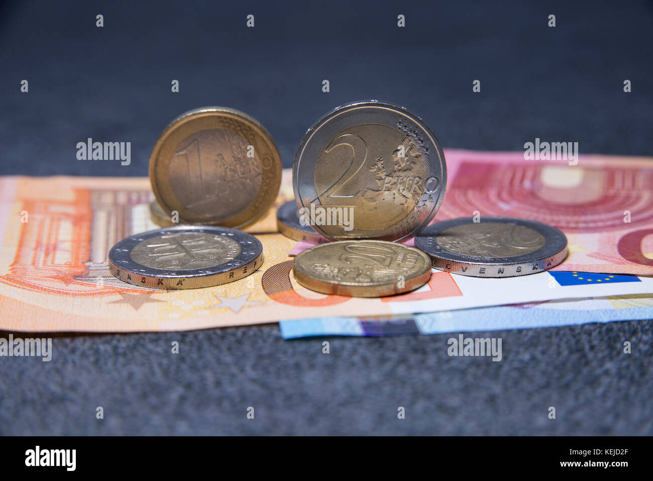 Euro banknotes and coins on the grey table Stock Photo - Alamy