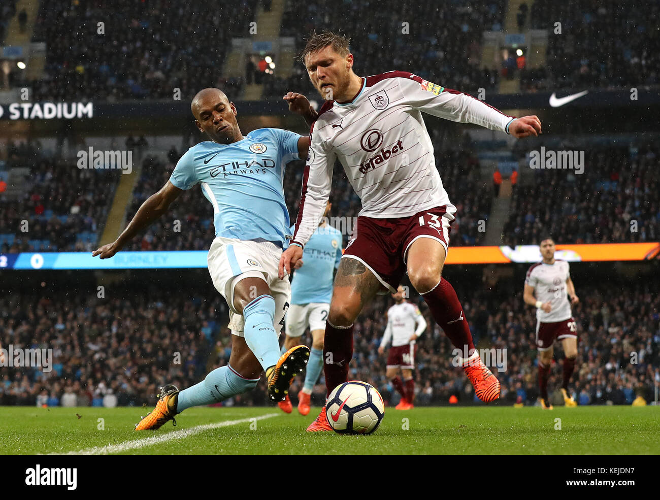 Manchester City's Fernandinho (left) and Burnley's Jeff Hendrick battle ...