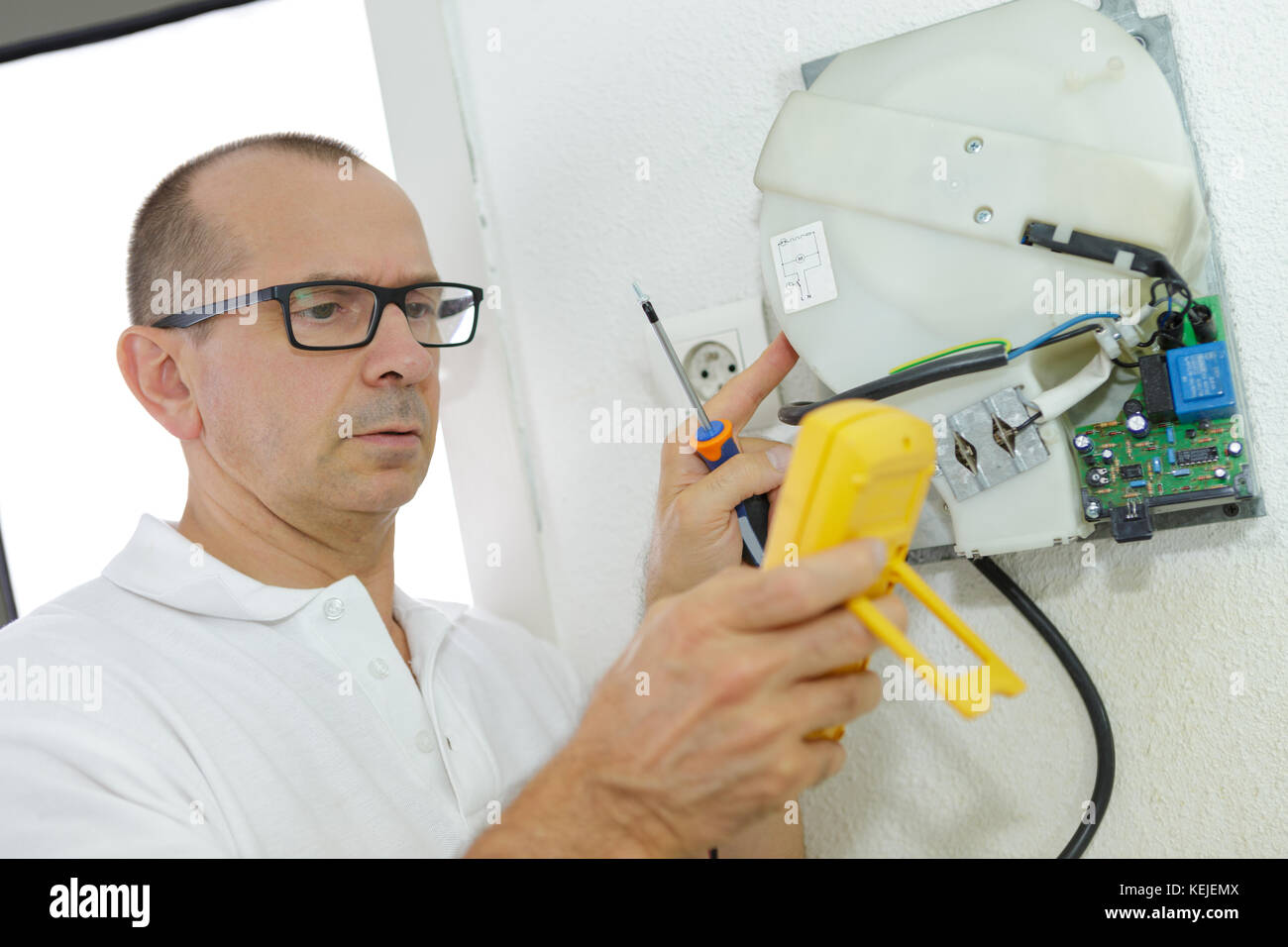 electrician examining current voltage with screwdriver tester Stock ...