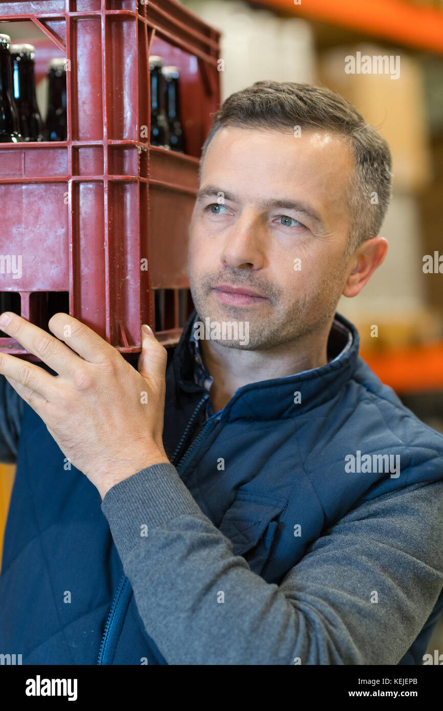 man carrying bottle case Stock Photo - Alamy