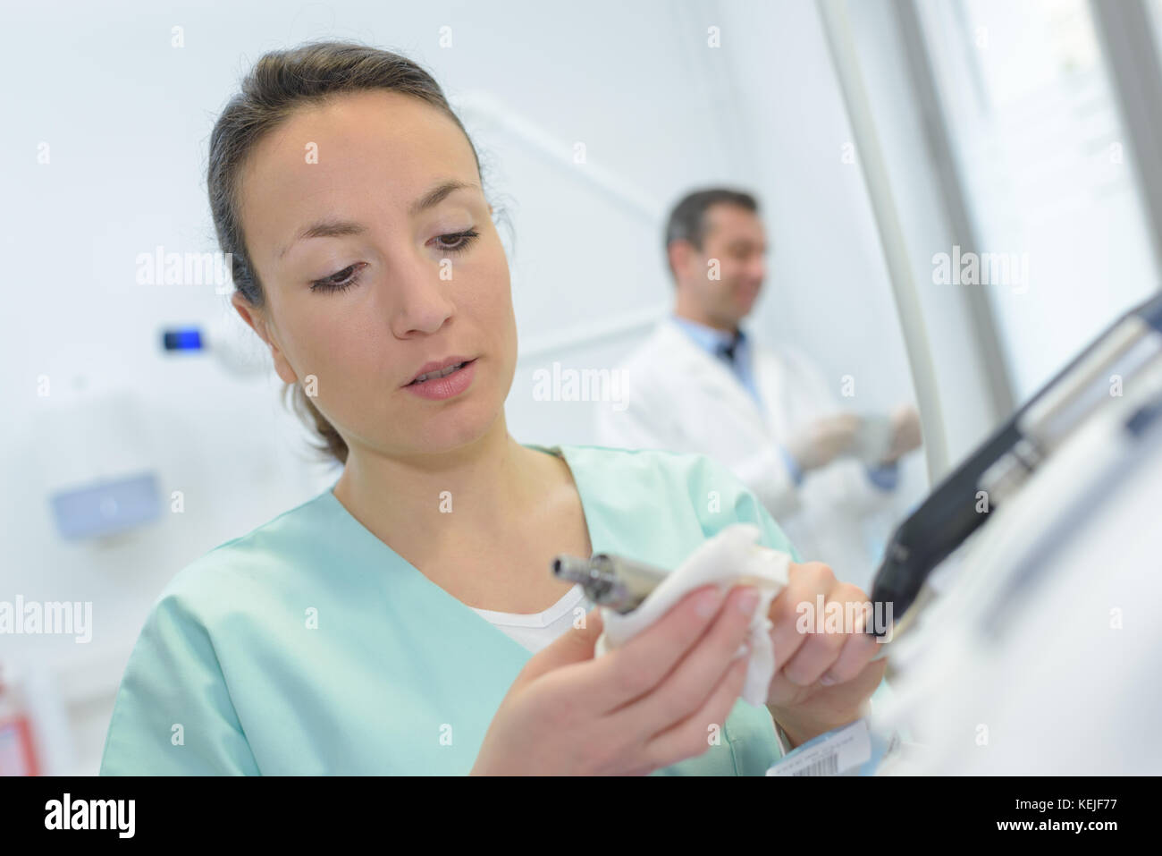 young woman washing and sterilizing medical instruments in a hospital ...