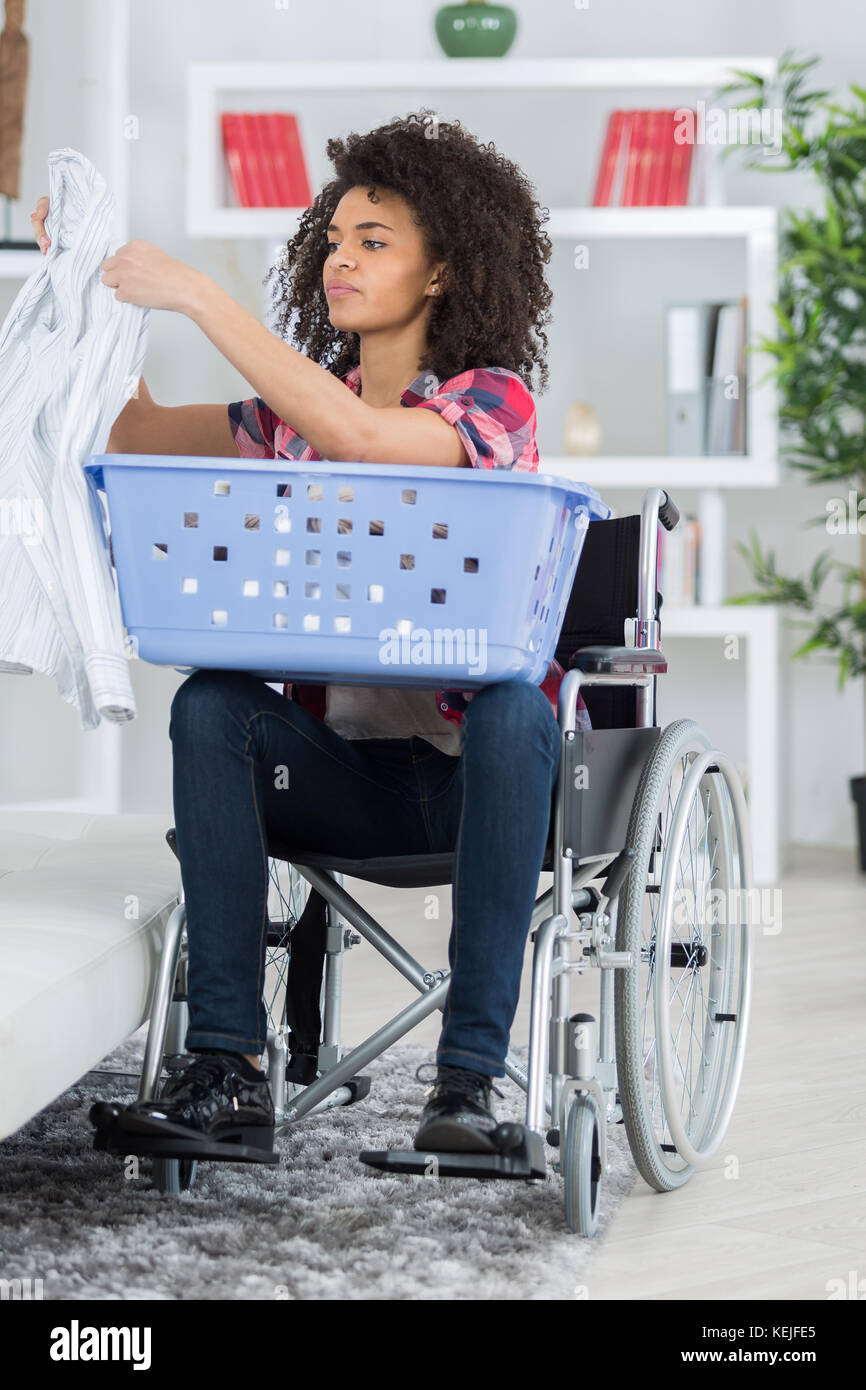 woman on the wheelchair sorting the laundry Stock Photo - Alamy