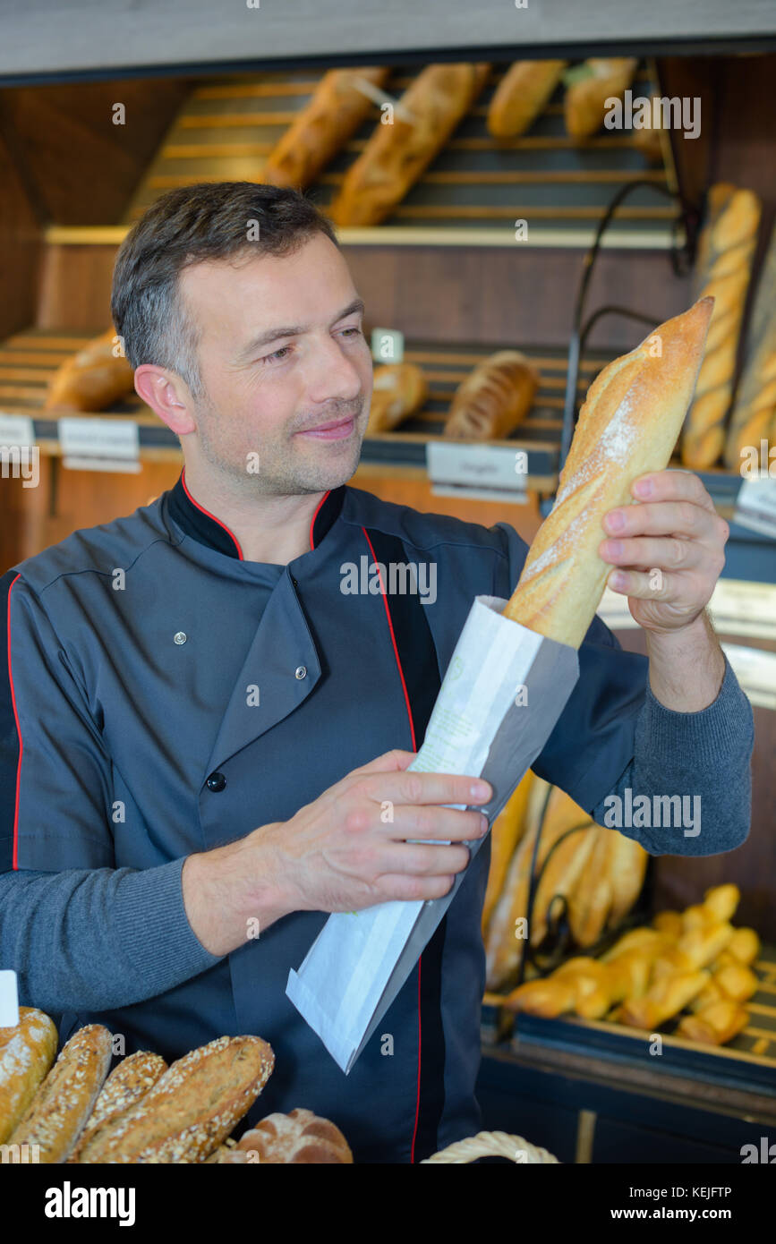 bakery shopkeeper is proud of his bread production Stock Photo - Alamy