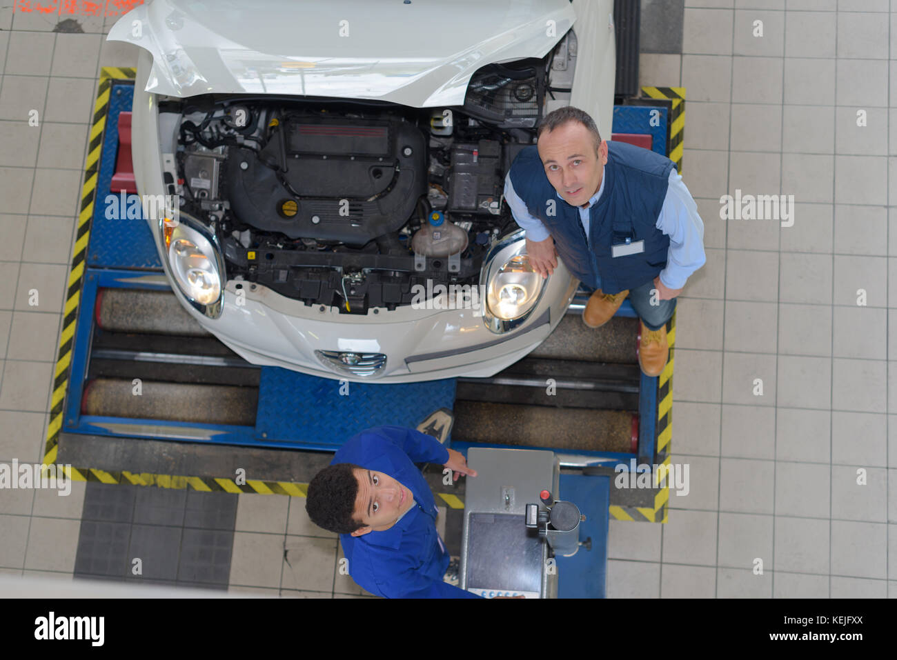 top view of a mechanic and apprentice working Stock Photo - Alamy