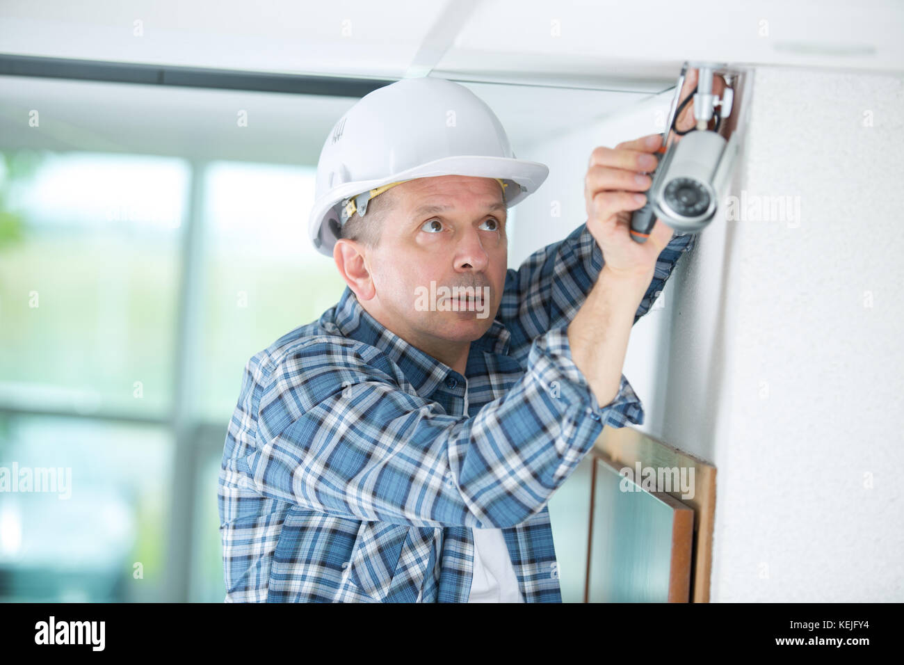 technician worker installing video surveillance camera on wall Stock ...