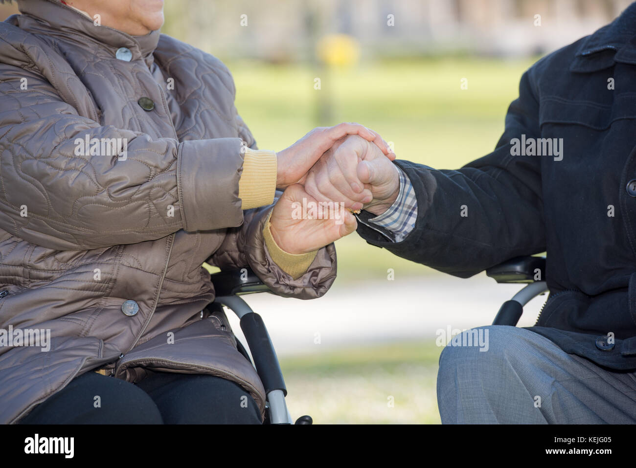 elderly couple holding hands Stock Photo - Alamy