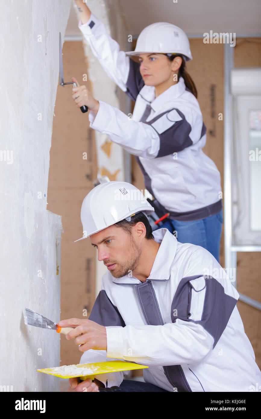 team finishing the plaster board Stock Photo - Alamy