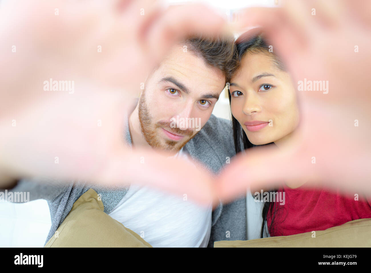 Couple making a heart sign Stock Photo - Alamy