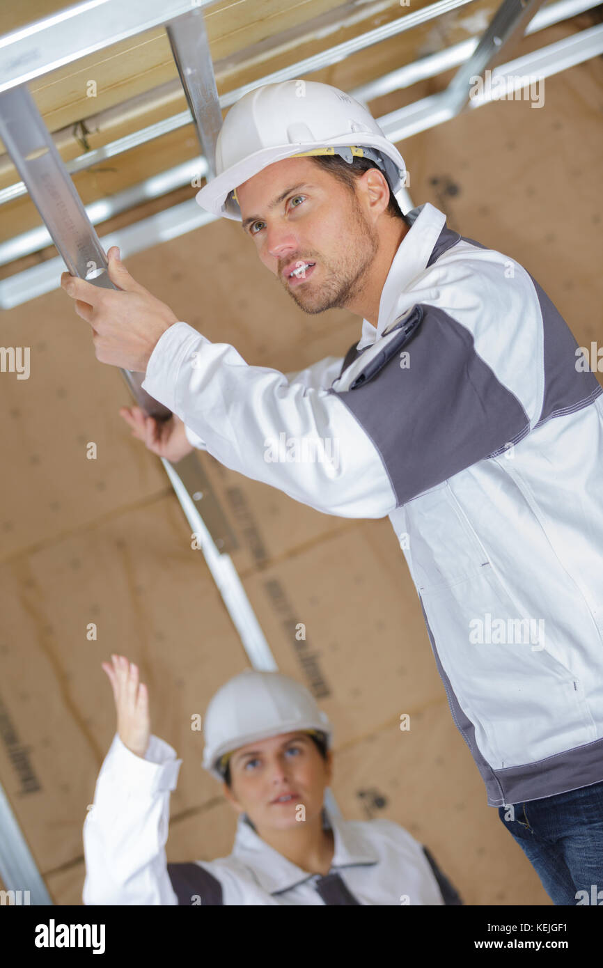 construction worker building ceiling frame Stock Photo - Alamy