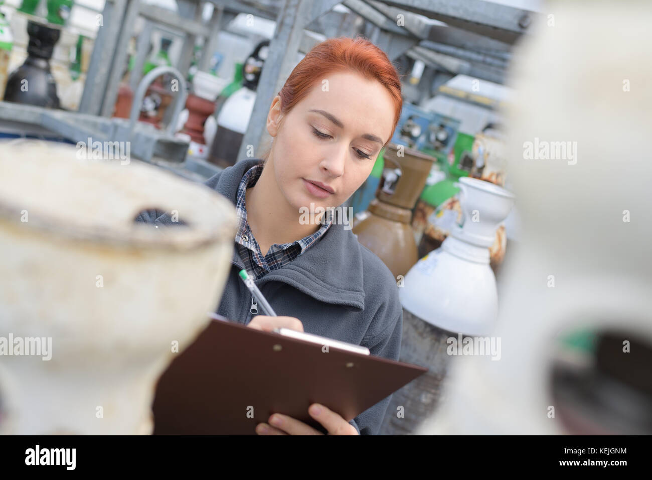 mechanical engineer taking notes at metallurgy factory Stock Photo - Alamy