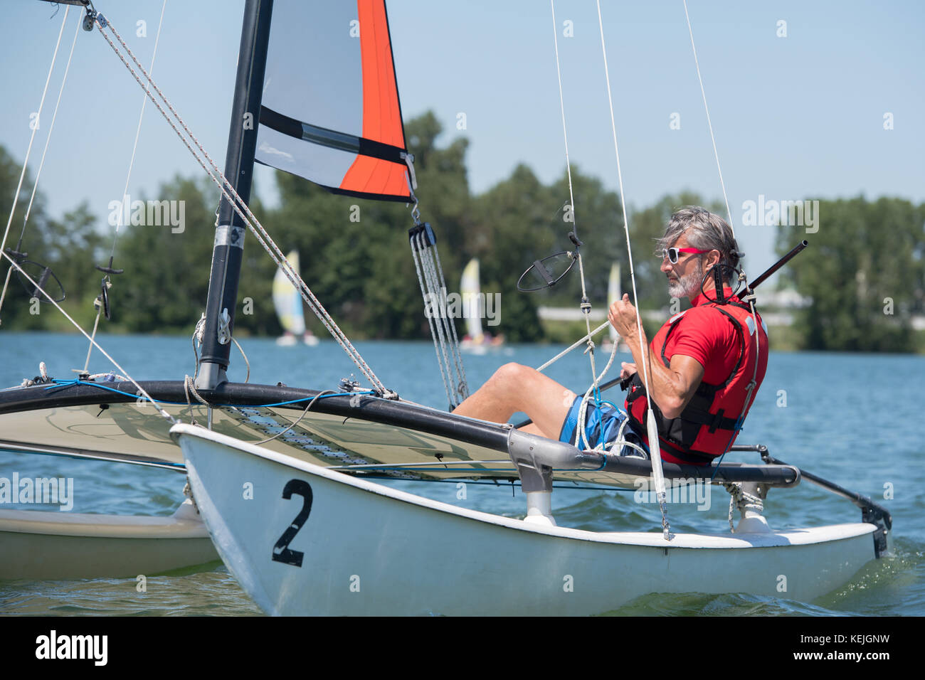 Man on sailing vessel Stock Photo - Alamy