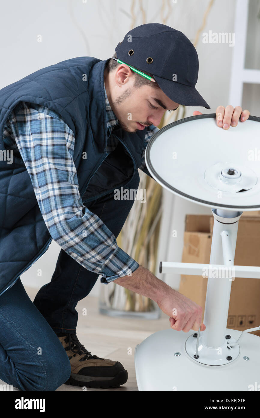 Man assembling office stool Stock Photo - Alamy
