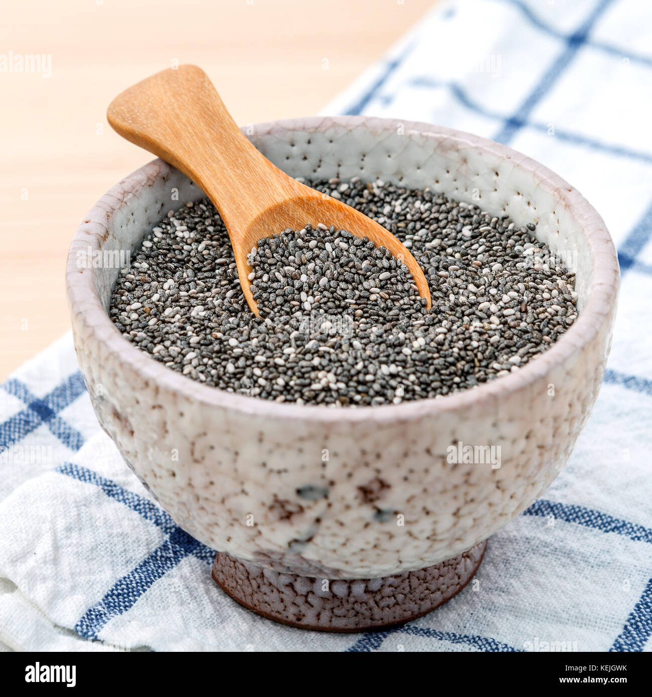 Nutritious chia seeds in ceramic bowl with wooden spoon for diet food ...