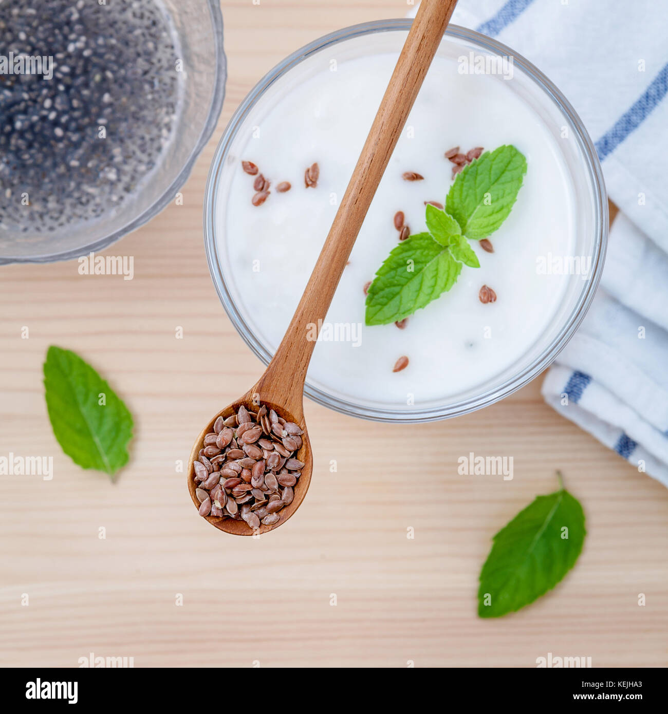 Nutritious flax seeds with glass of greek yogurt and wooden spoon for ...