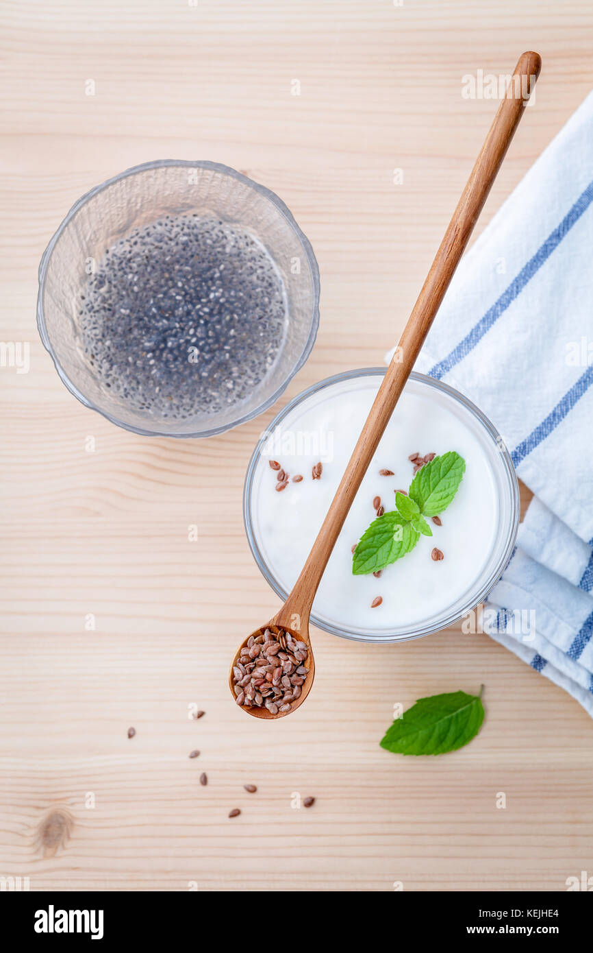 Nutritious flax seeds with glass of greek yogurt and wooden spoon for ...
