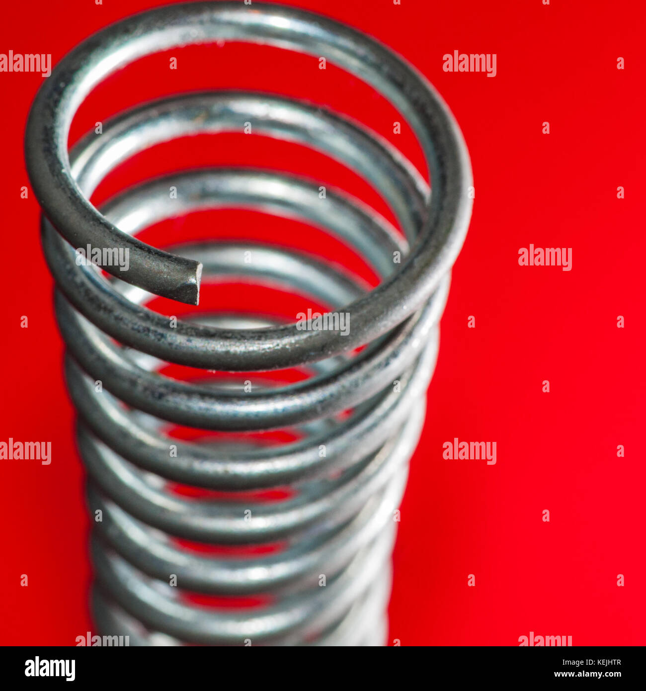 A close-up abstract shot of a metal spring used to hold soldering irons ...