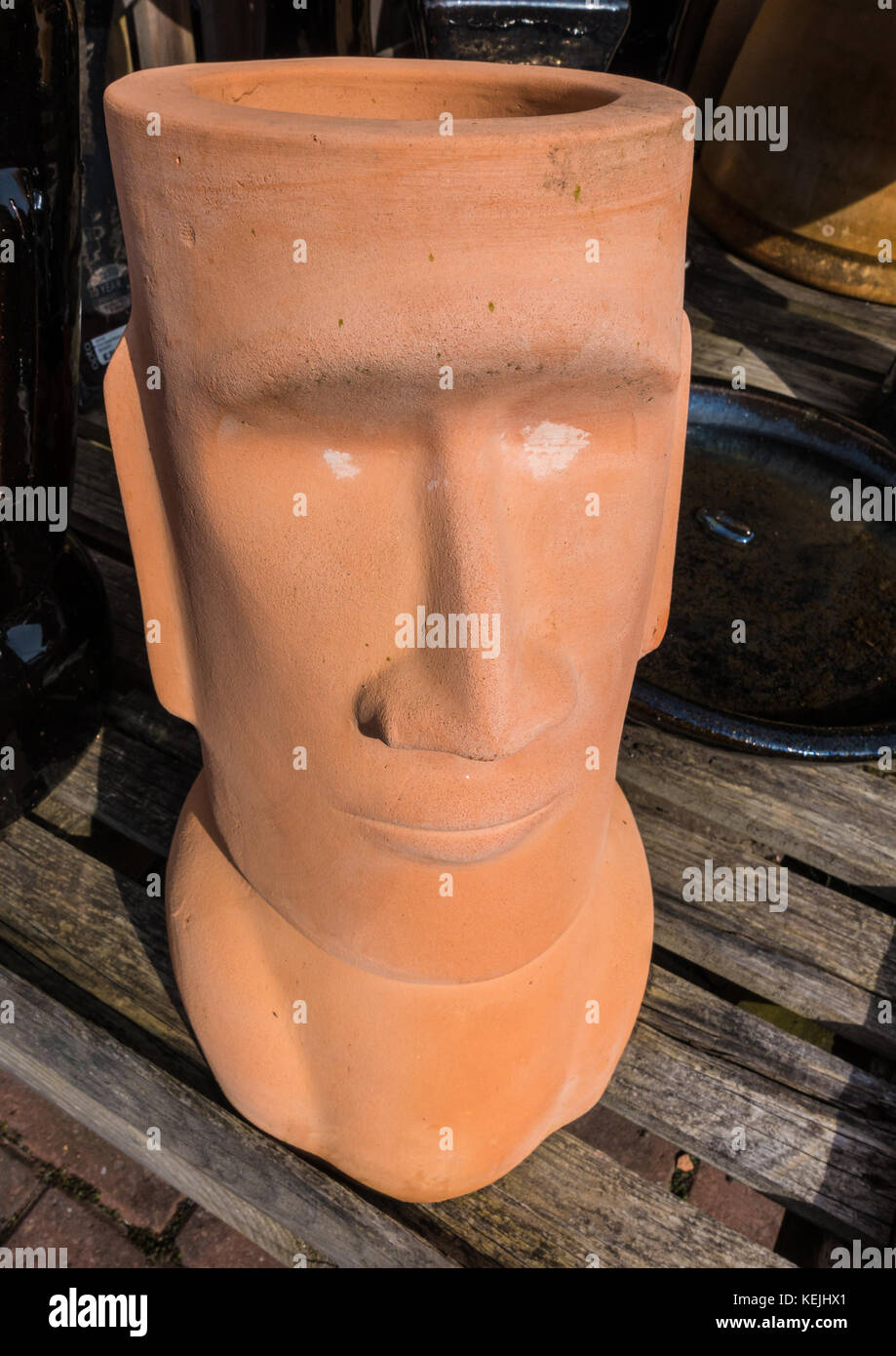 A terracotta pot fashioned as a Moai head Stock Photo - Alamy