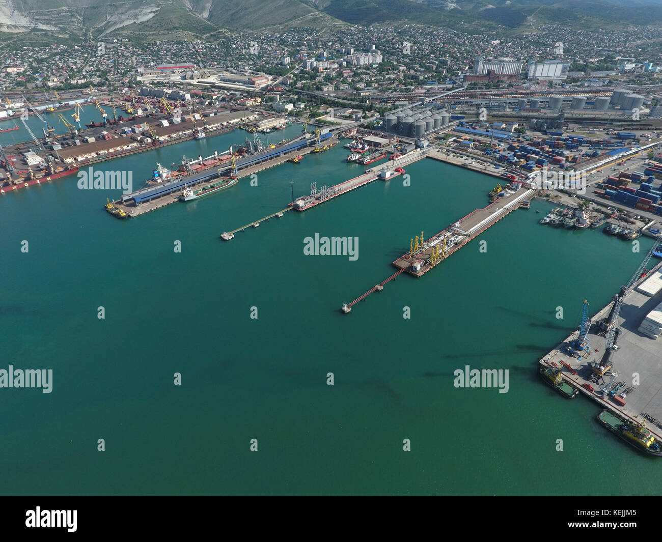Industrial seaport, top view. Port cranes and cargo ships and barges ...