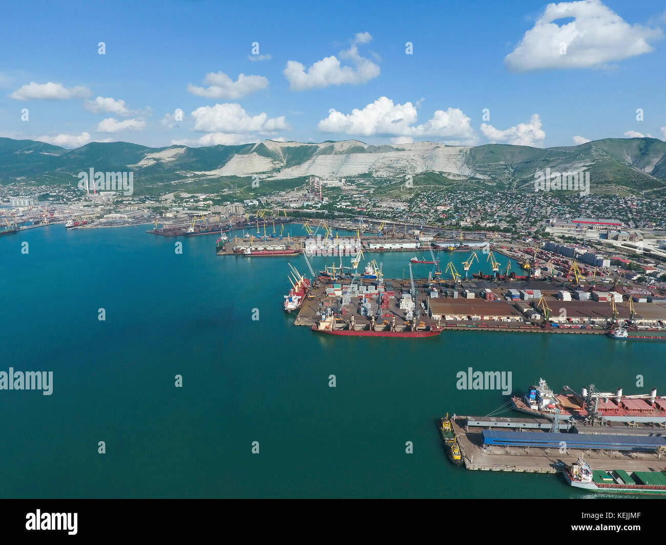 Industrial seaport, top view. Port cranes and cargo ships and barges ...