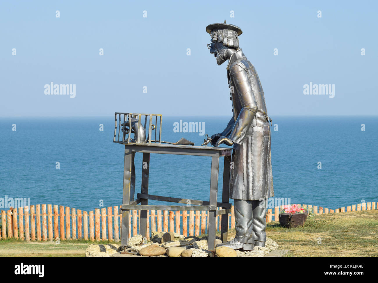 Statue of a furrier from metal with a rat in a cage. Metal statue Stock ...
