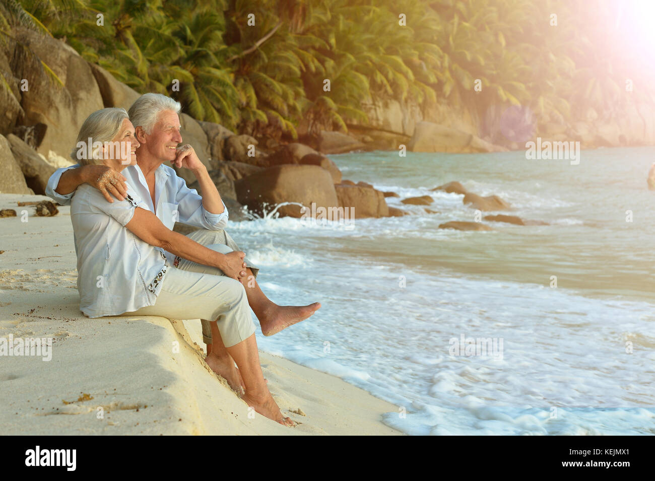 couple relaxing on tropical beach Stock Photo - Alamy