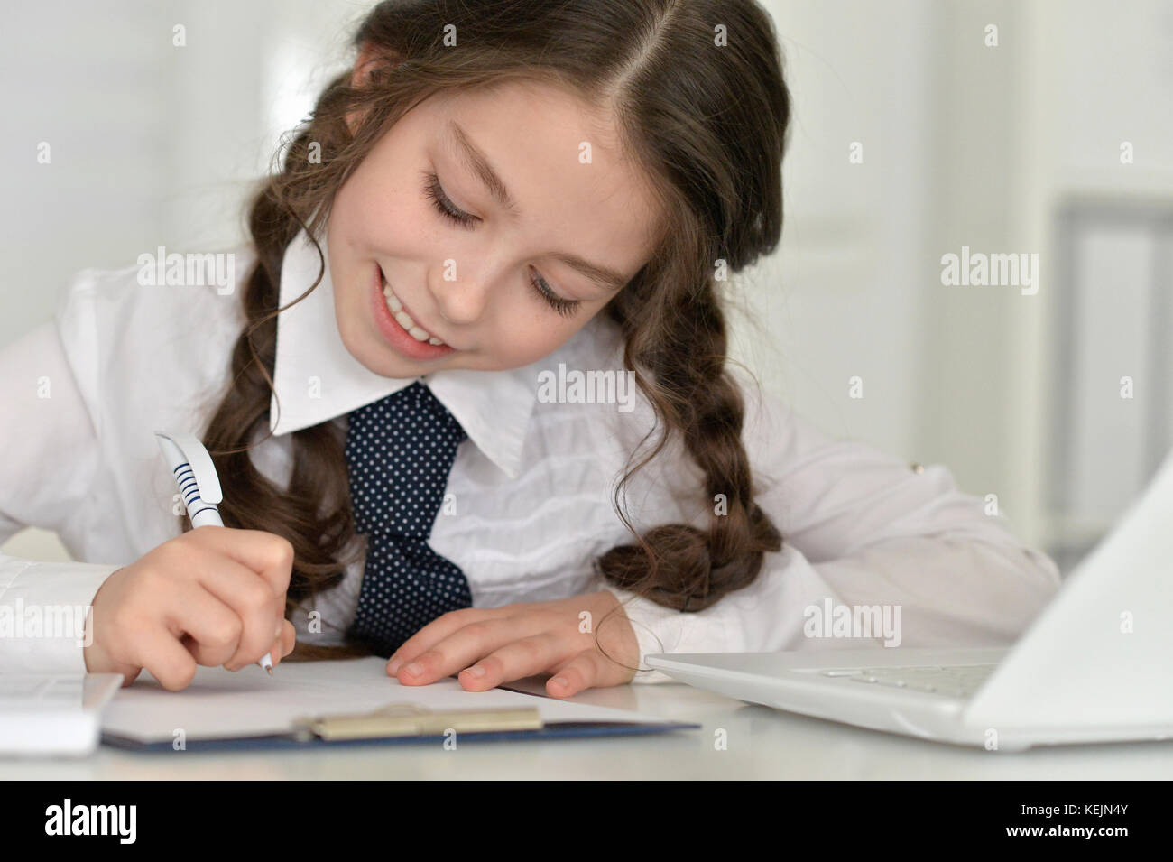 Cute girl doing homework Stock Photo - Alamy
