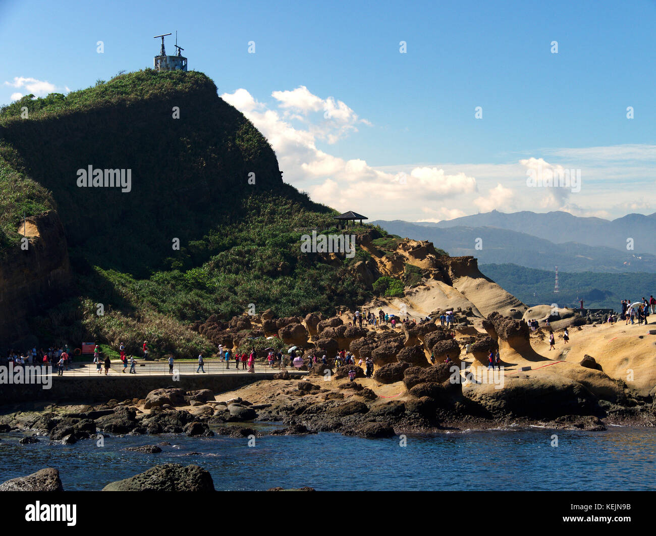 Visitors exploring the Mushroom Rocks formation at Yehliu Geopark ...
