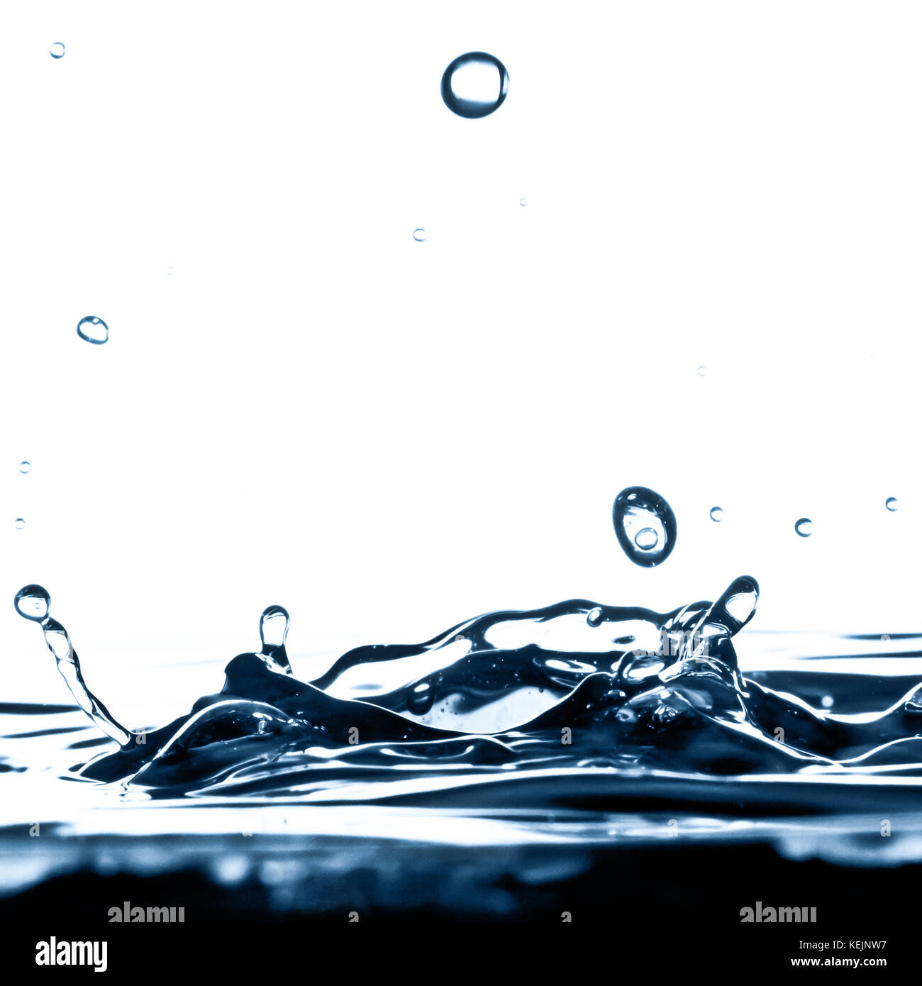 A water splash caused by an object falling into a bowl of water Stock ...