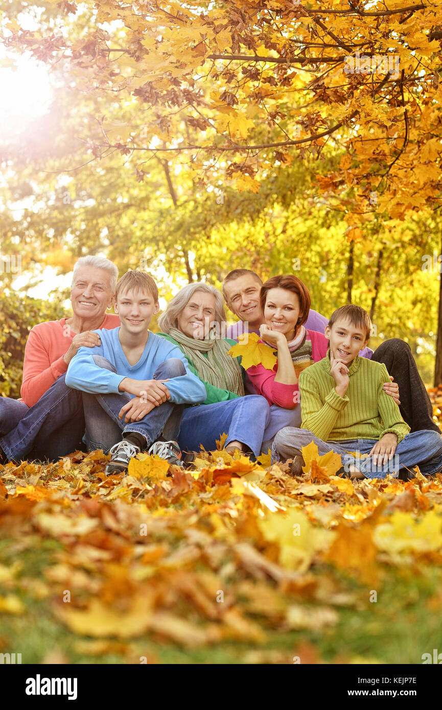 Big family sitting on ground Stock Photo - Alamy