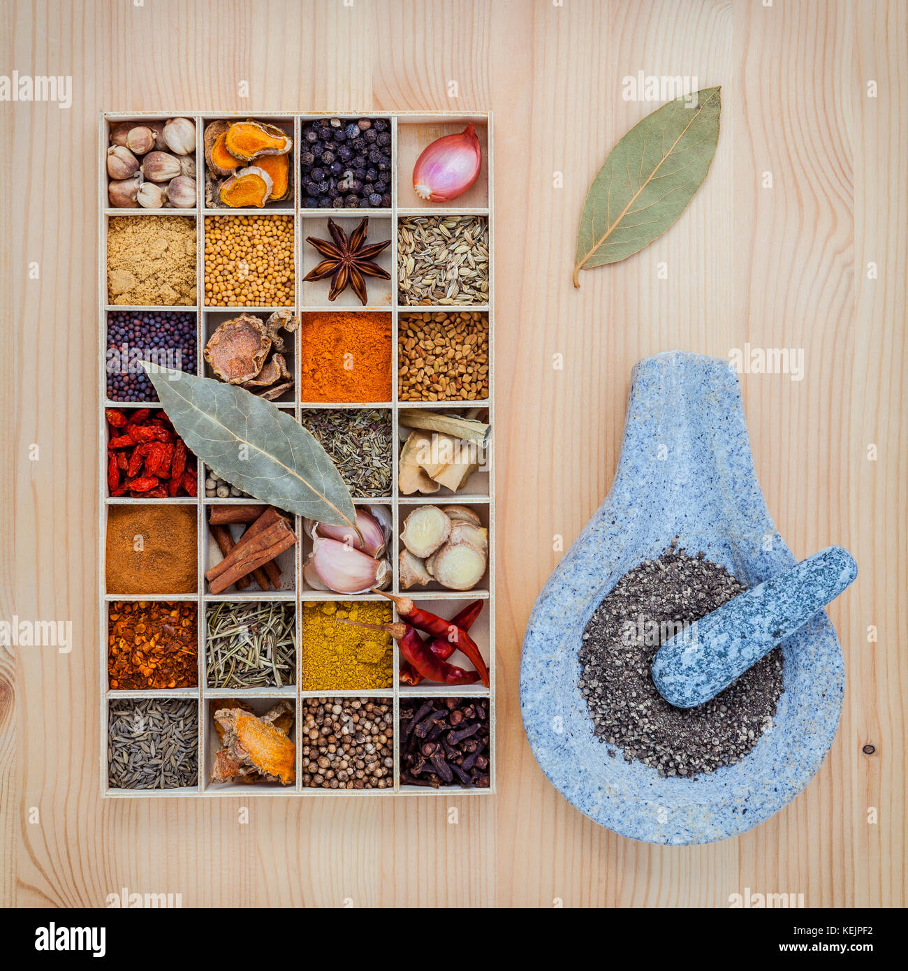 Assortment of spices food cooking ingredients in wooden box and mortar ...