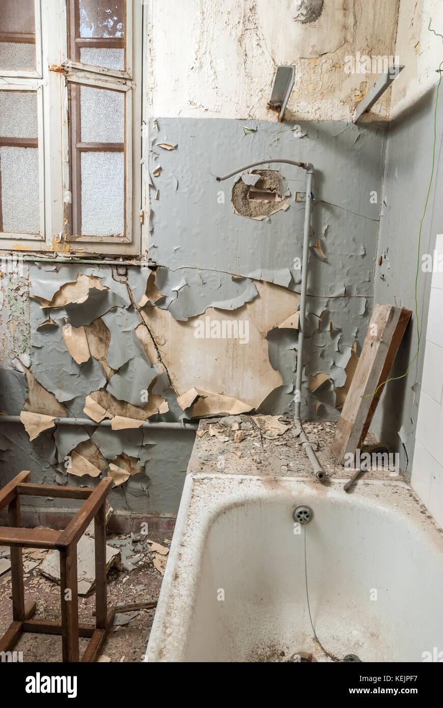 Bathroom with bathtub, sink and window in abandoned sanatorium ...