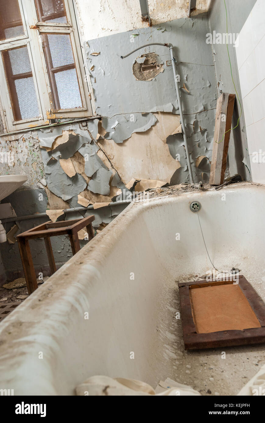 Bathroom with bathtub, sink and window in abandoned sanatorium ...