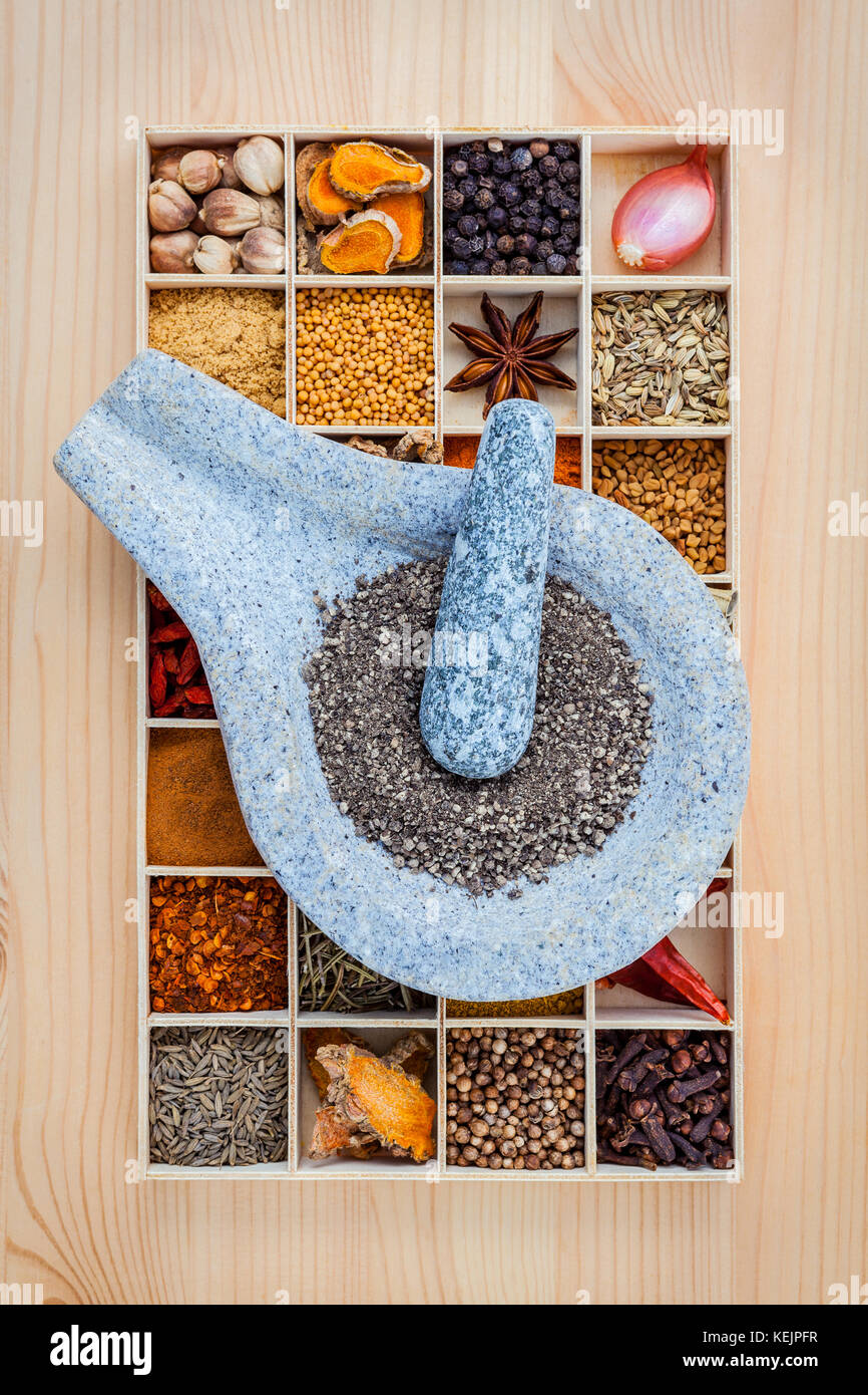 Assortment of spices food cooking ingredients in wooden box and mortar ...