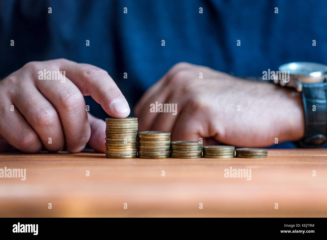 Man stacking money as concept for success or savings, investment and ...