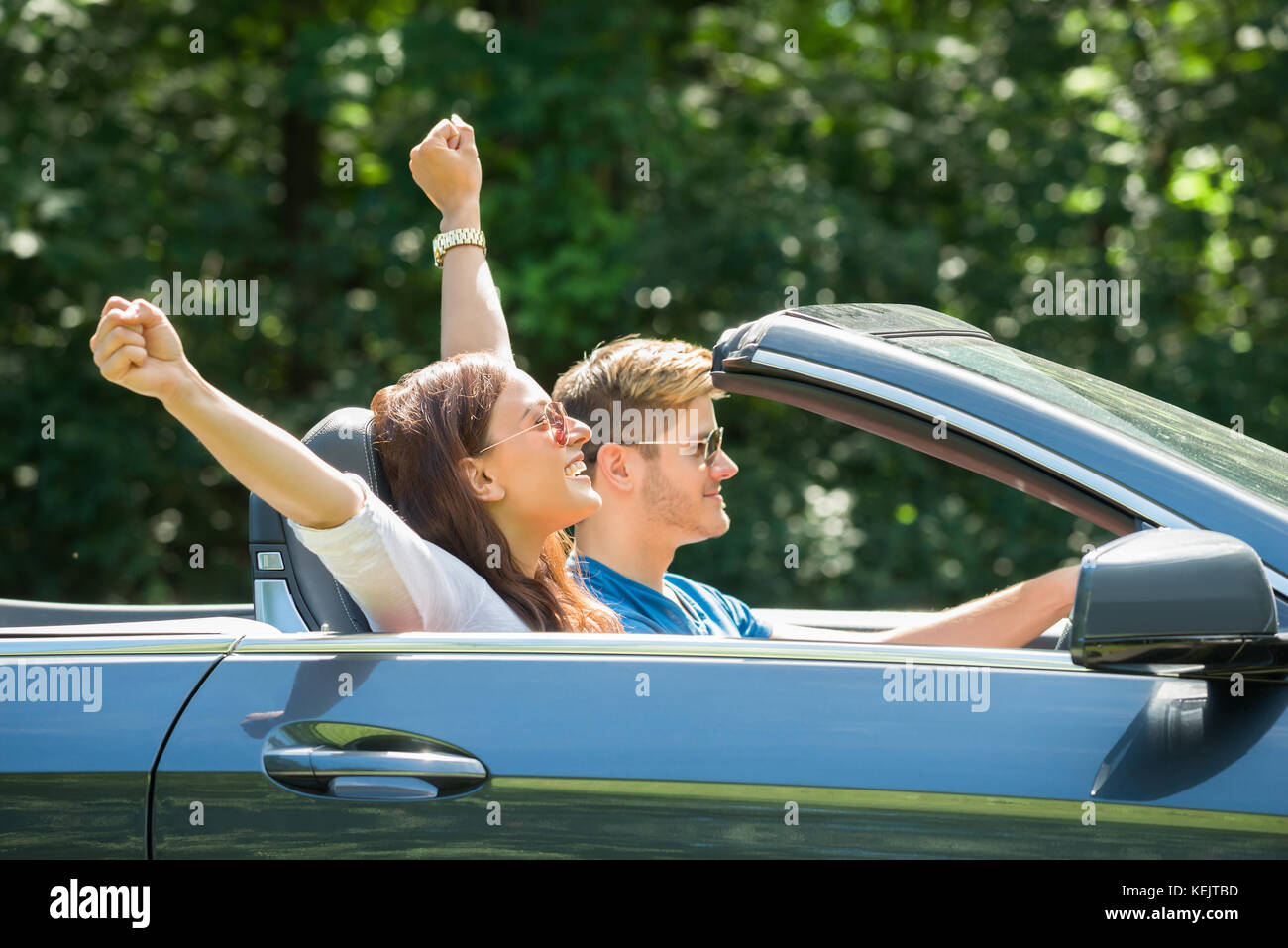 Happy Young Couple Enjoying Drive In A Car Stock Photo - Alamy