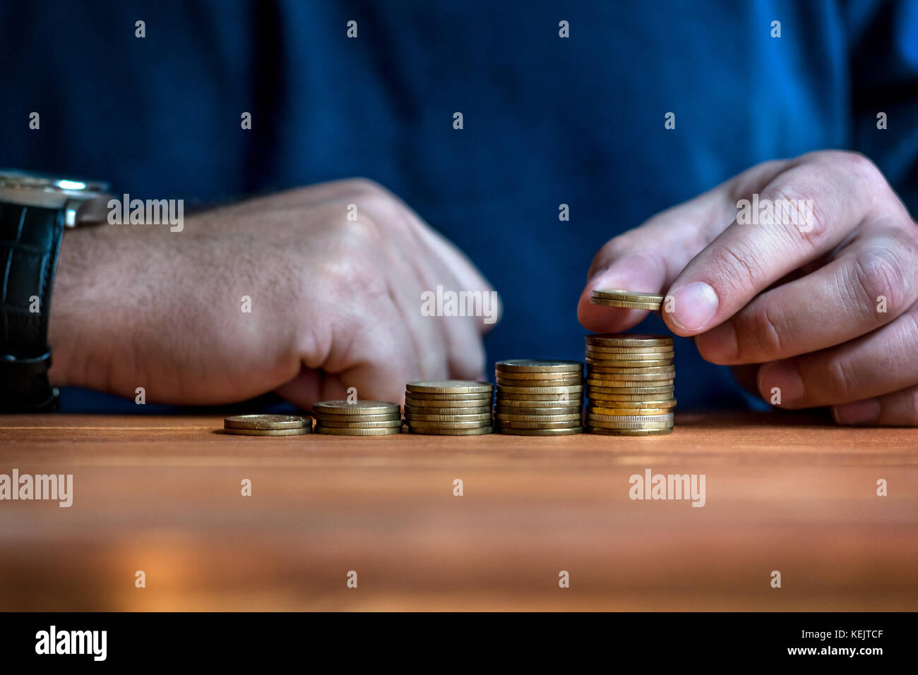 Man stacking money as concept for success or savings, investment and ...