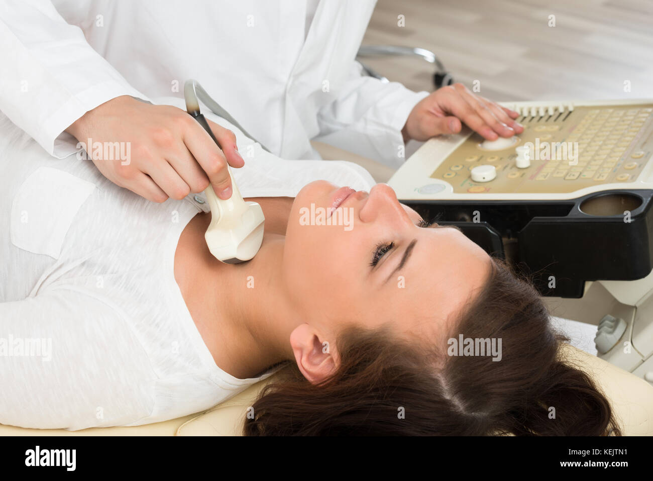 Young Woman Doing Neck Ultrasound Examination At Hospital Stock Photo ...