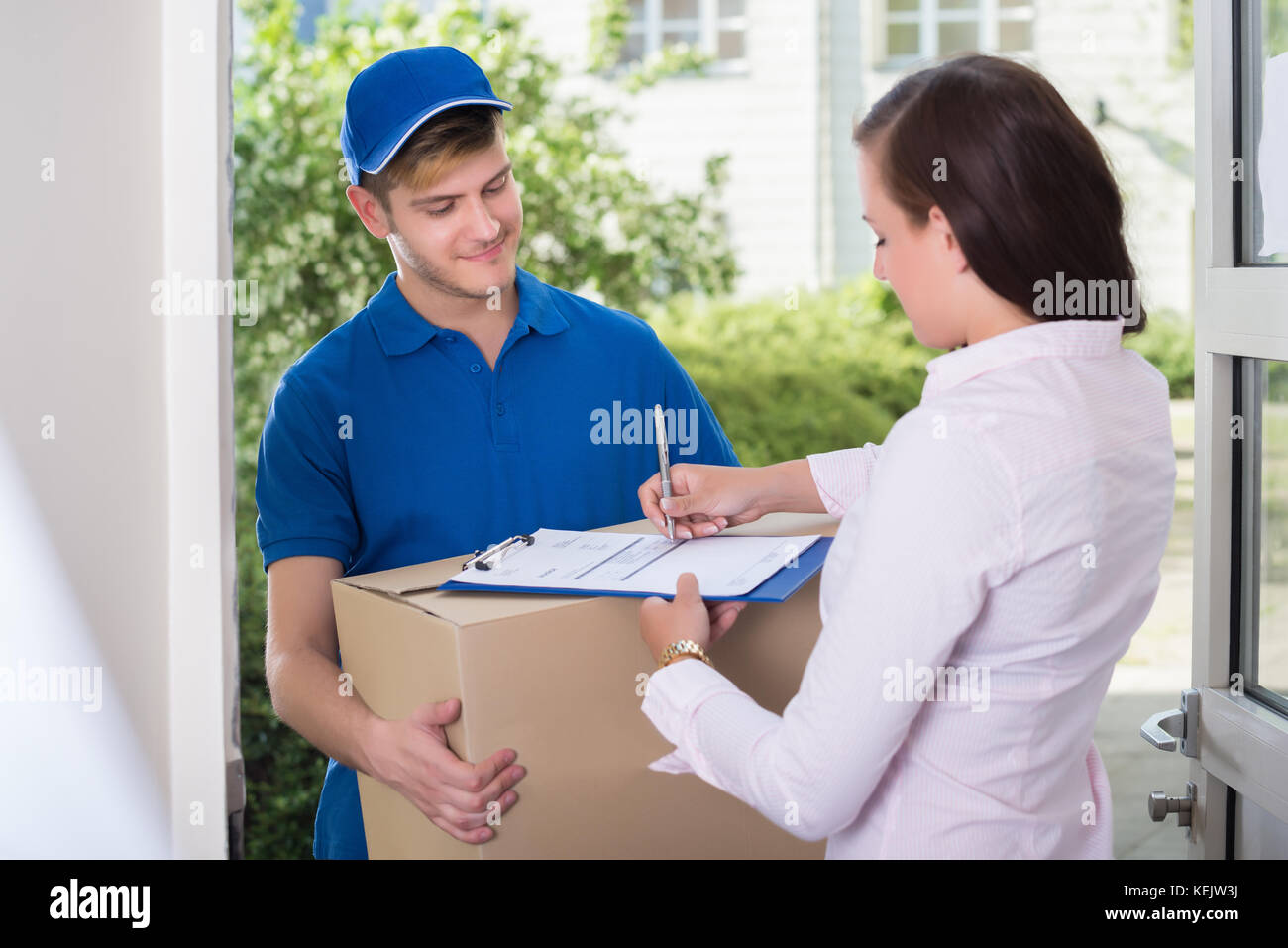 Signing for package hi-res stock photography and images - Alamy