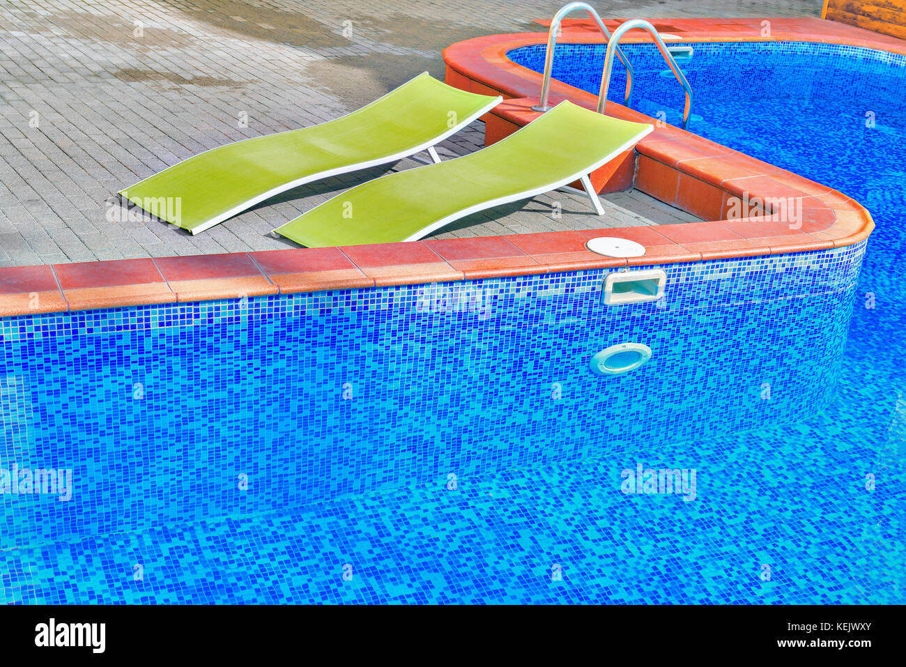 Two chaise-longues by the swimming pool on the hotel territory Stock ...